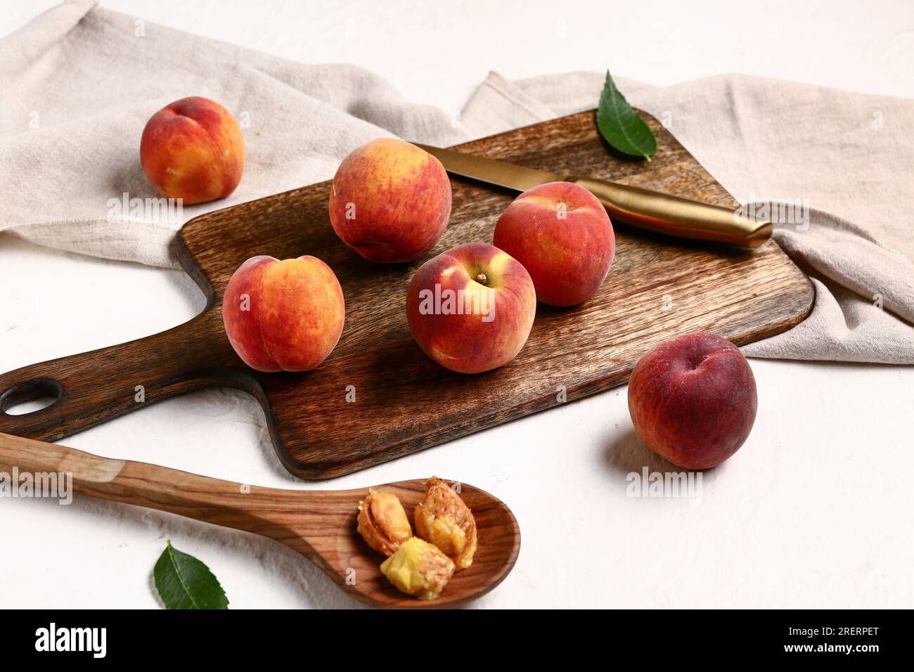 Wooden board with sweet peaches on white background Stock Photo - Alamy