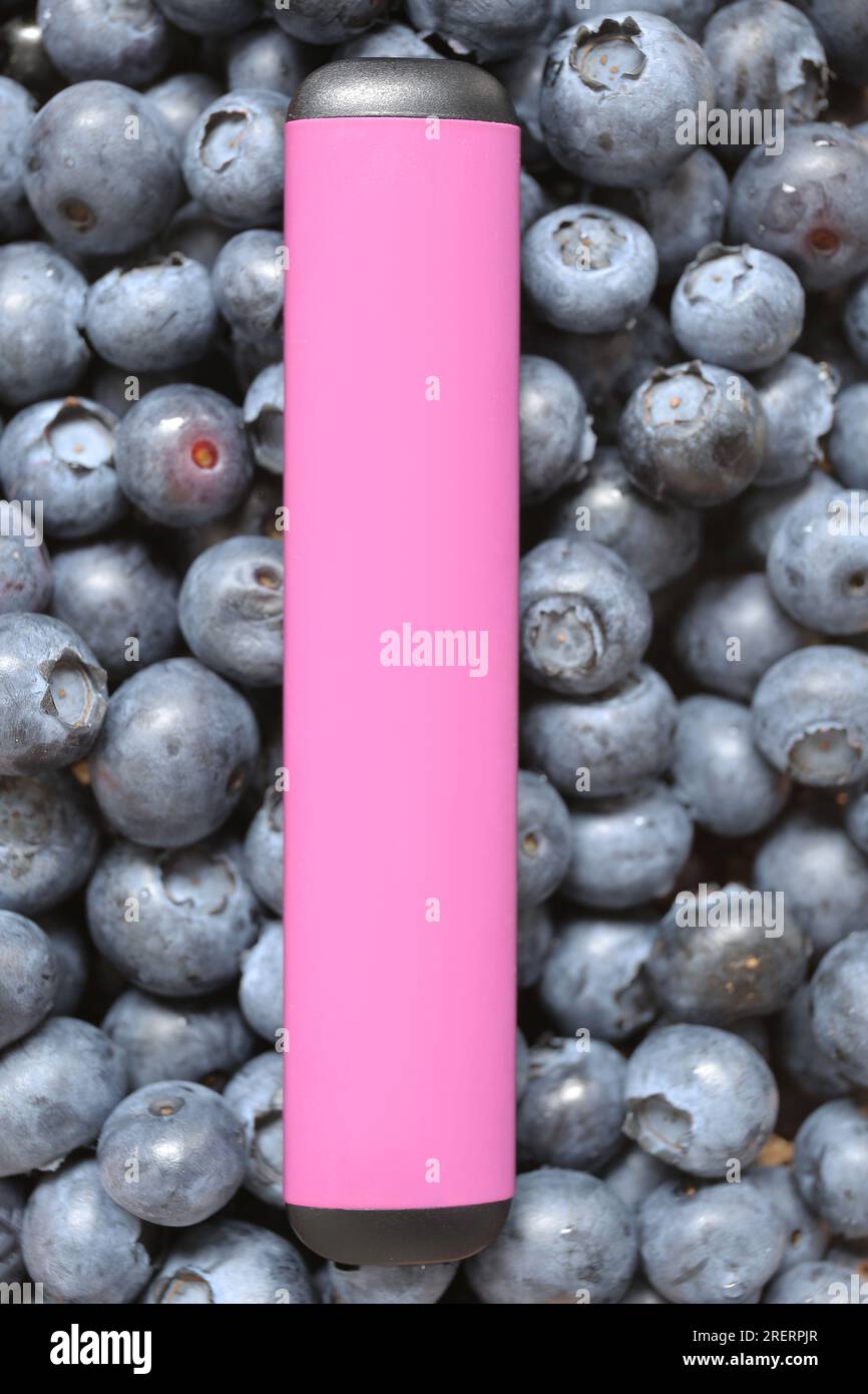 Electronic cigarette with blueberry, closeup Stock Photo - Alamy