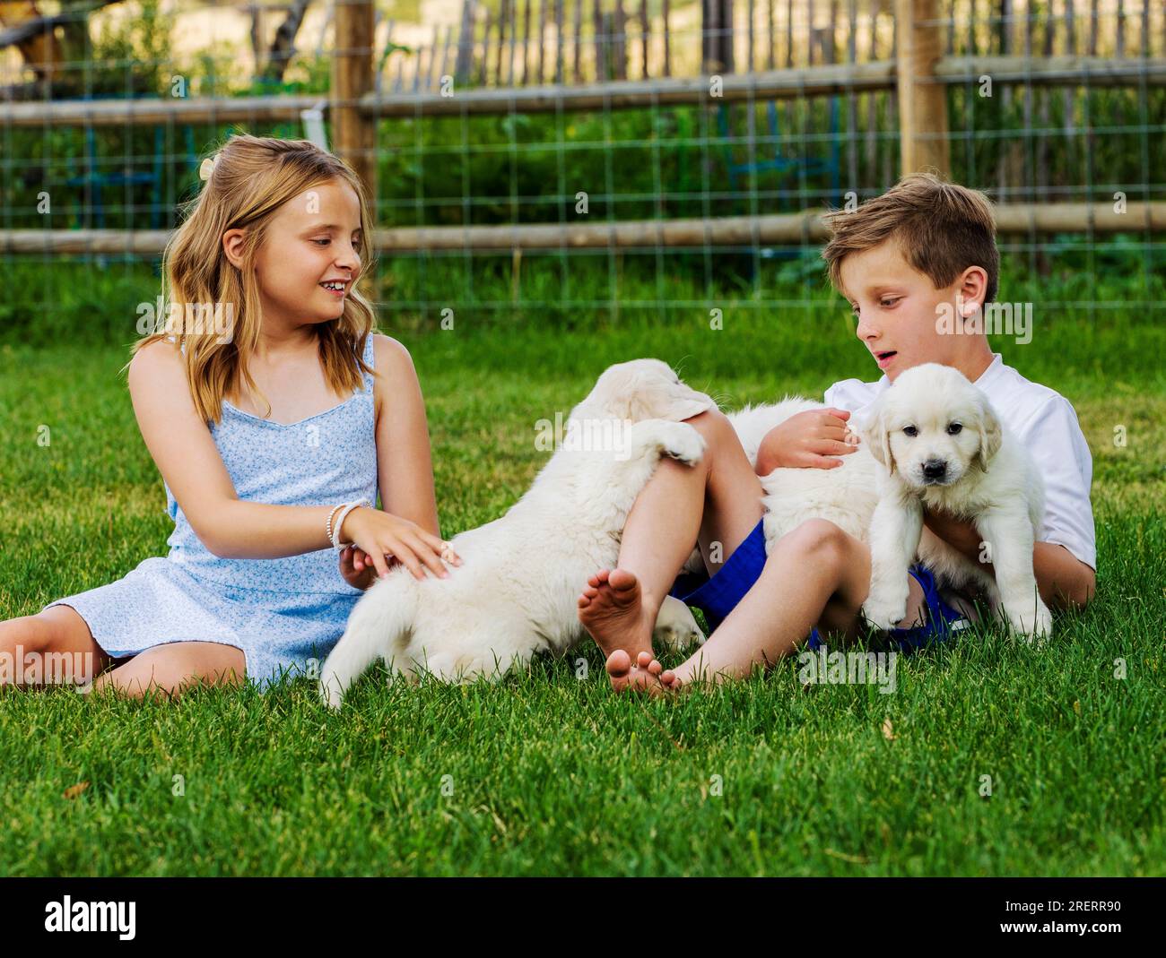 Young children playing outside on lawn with Platinum, or Cream colored ...