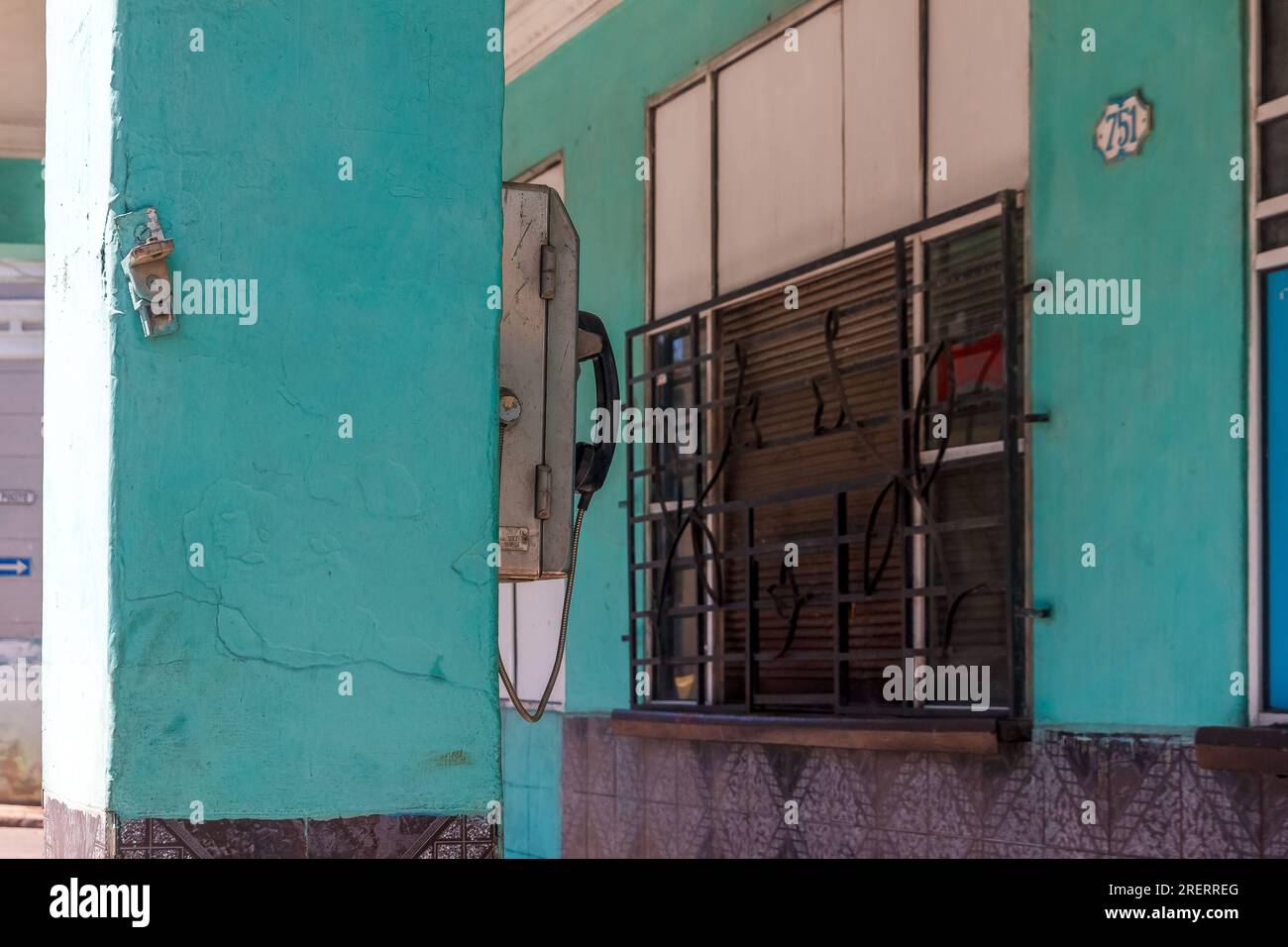Havana, Cuba, An Etecsa payphone in a porch column. A window is covered ...