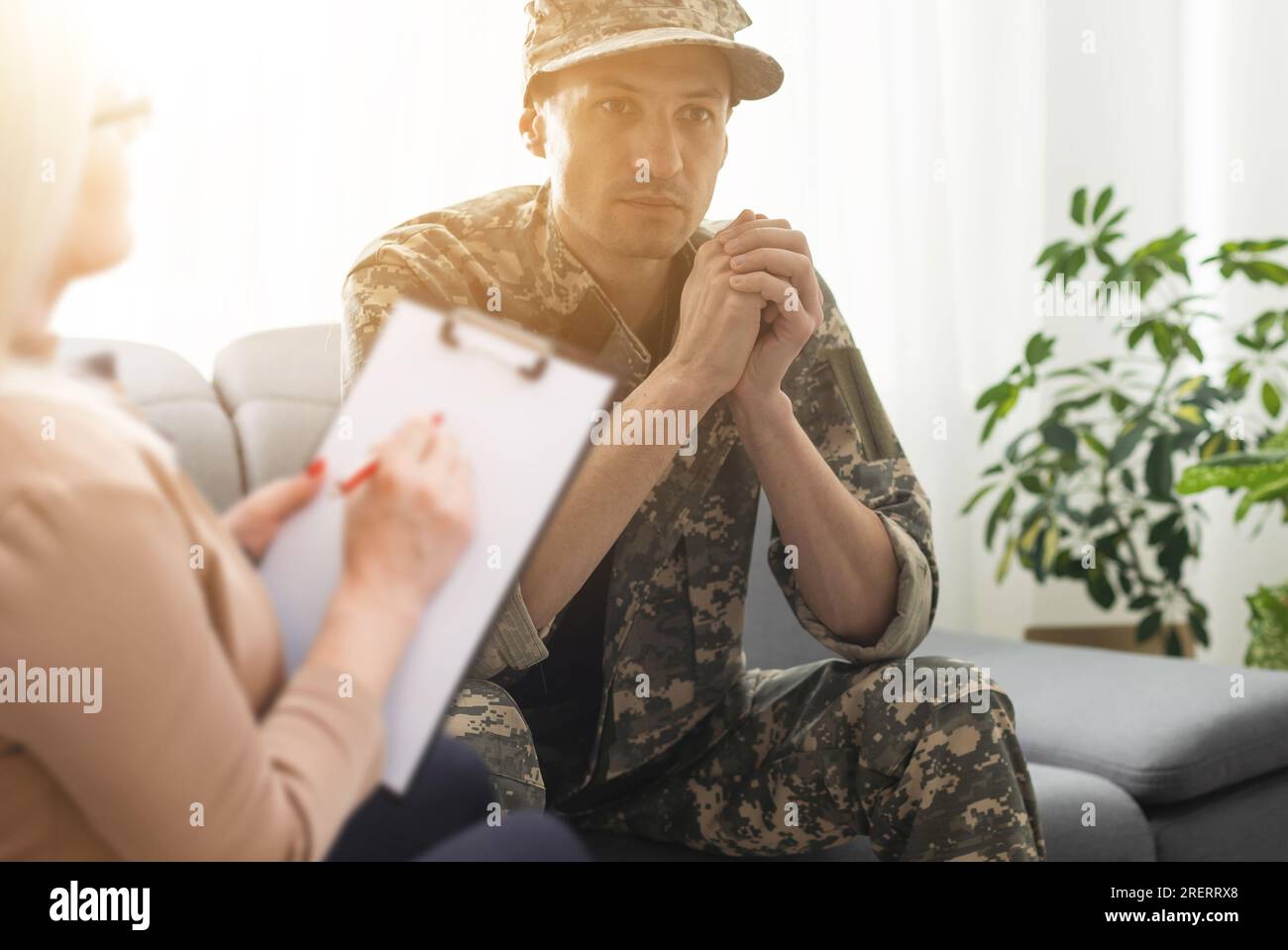 sad soldier with ptsd talking at psychiatrist and gesturing while ...