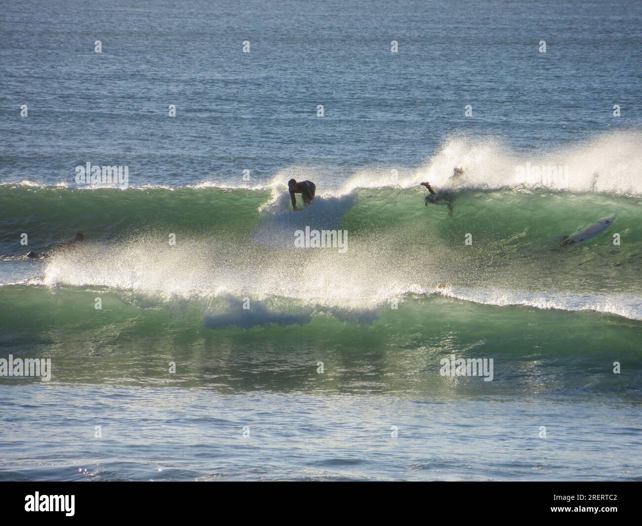 Group of surfers waiting for the perfect moment and the perfect wave in ...