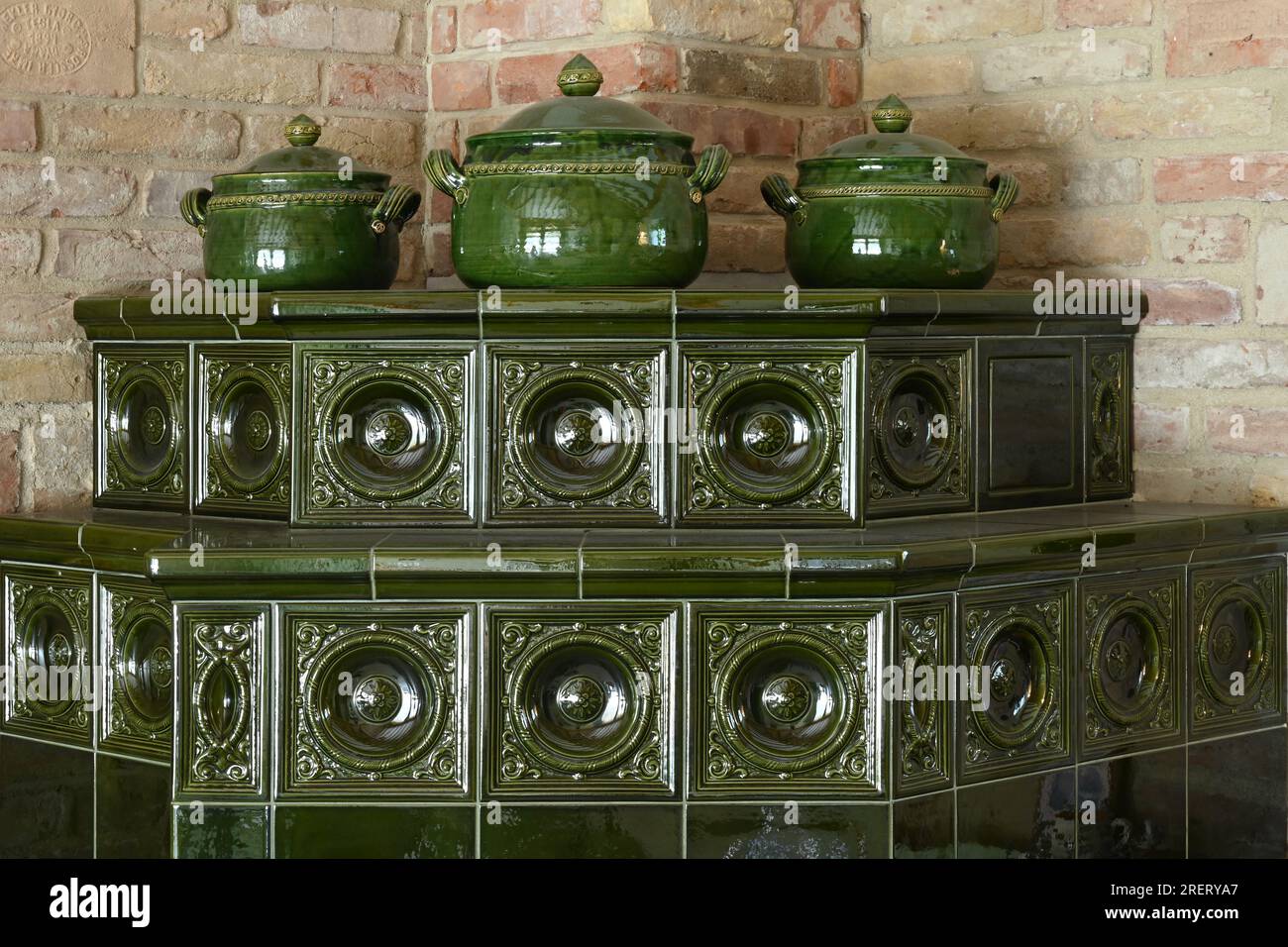 Decorative European green ceramic stove with intricate patterns and ...