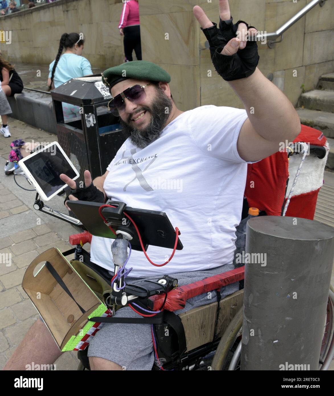 Manchester, UK, 29th July, 2023. A man wearing a green beret and using ...