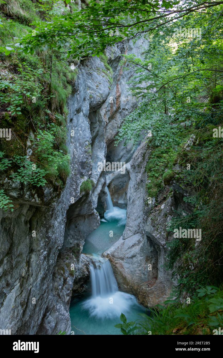 Waterfalls cascading in between narrow rock faces inside the ...