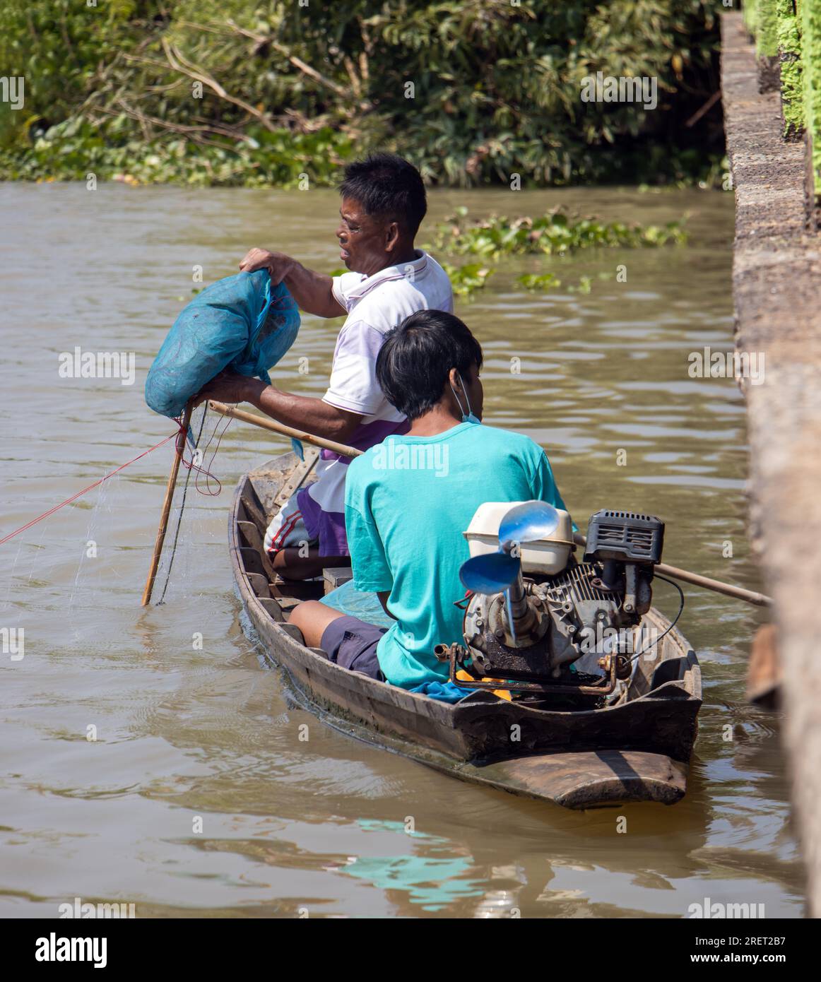 PRACHIN BURI, THAILAND, FEB 26 2023, A fishermen in a small boat catch ...