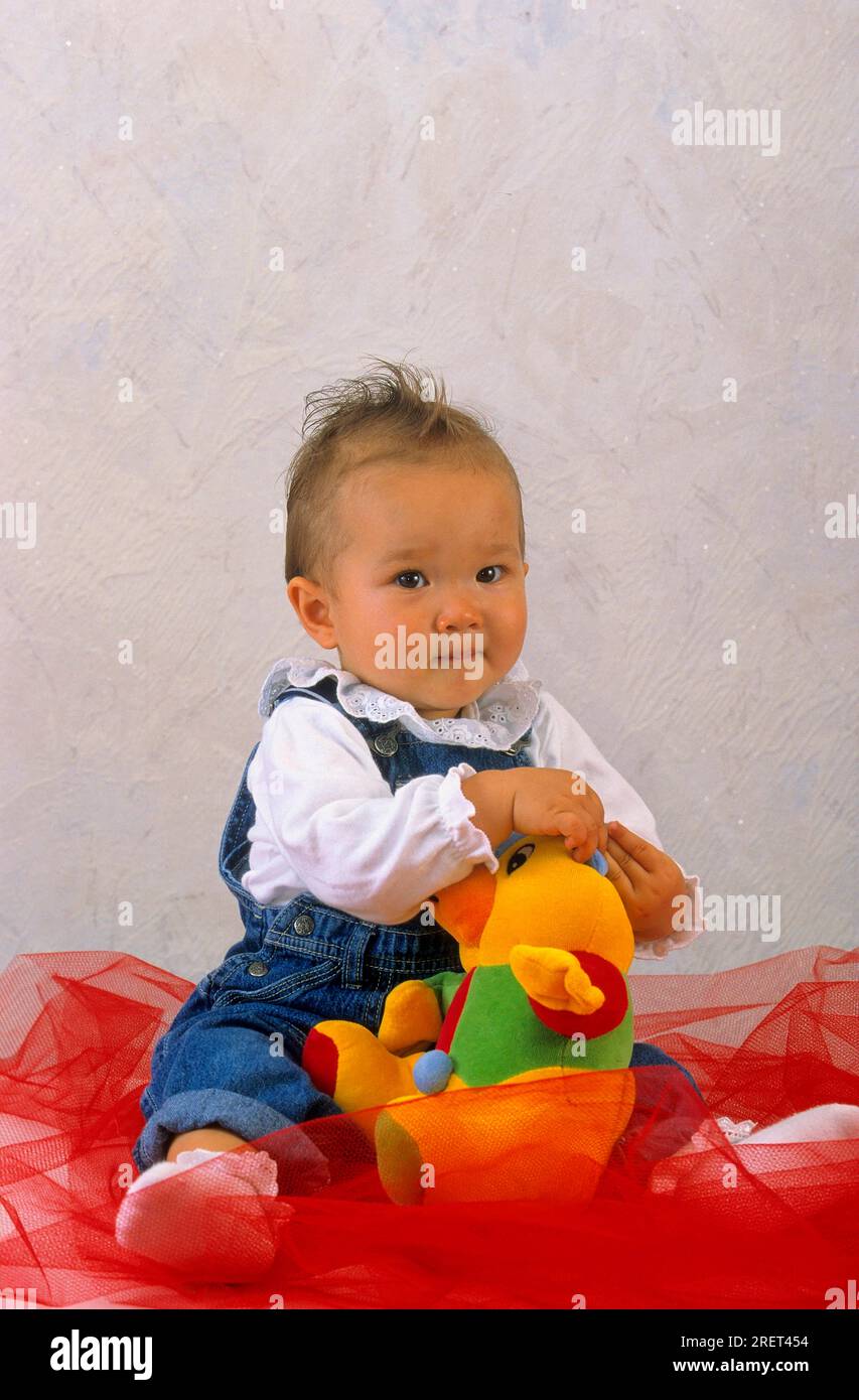 Baby under 1 year, girl with cuddly toy Stock Photo - Alamy