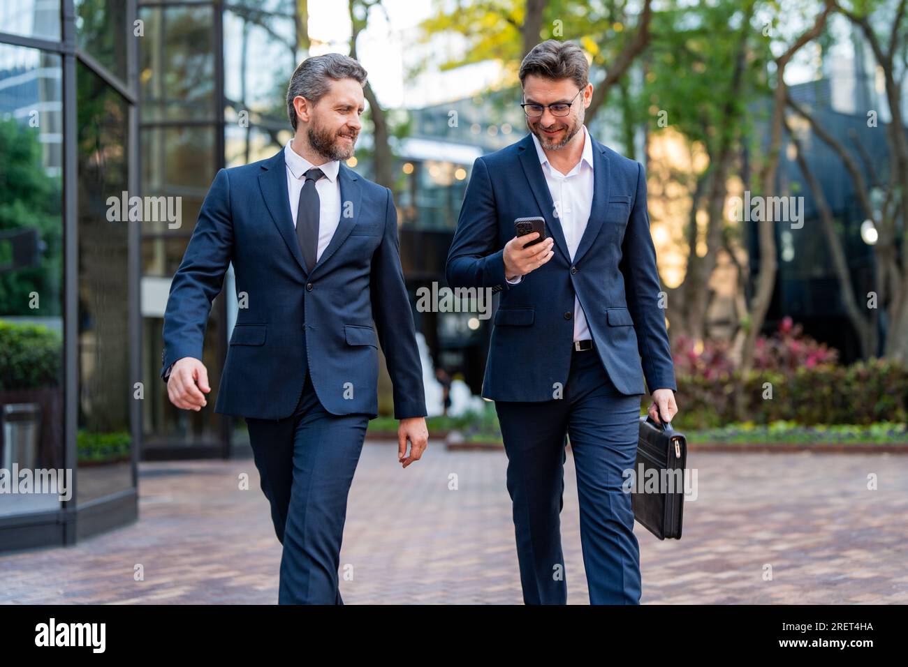 Business men walking across the street on american city outdoor ...