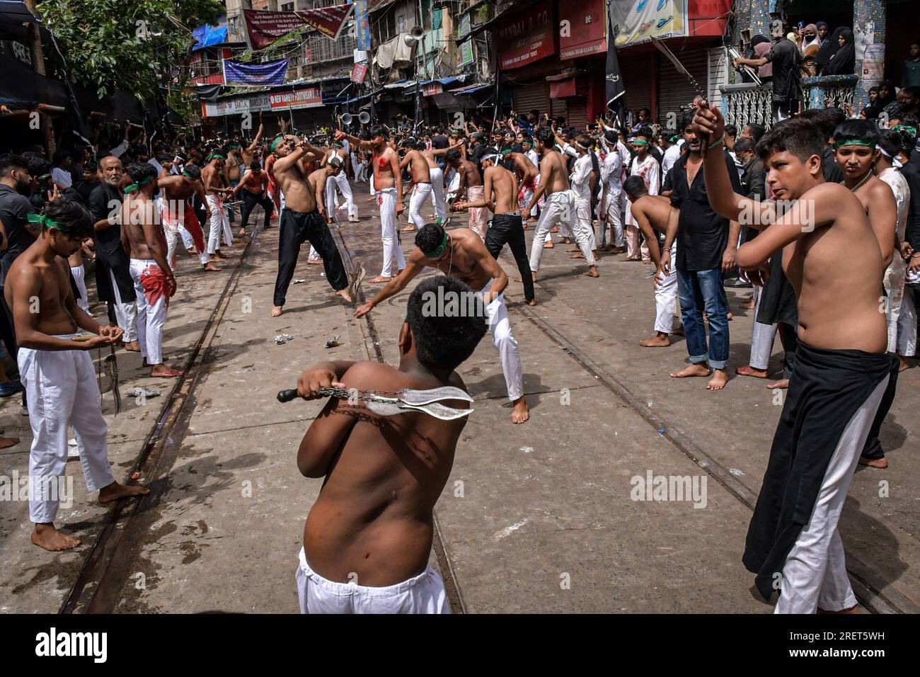 Kolkata, India. 29th July, 2023. Shia Muslim boys flagellate themselves ...