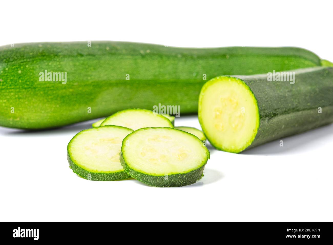 Courgettes (Cucurbita pepo), whole and cut, on white Stock Photo - Alamy