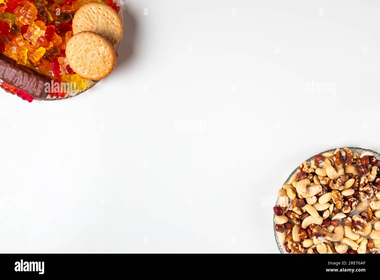 Comparison of unhealthy and healthy, various sweets and nuts, on plates ...