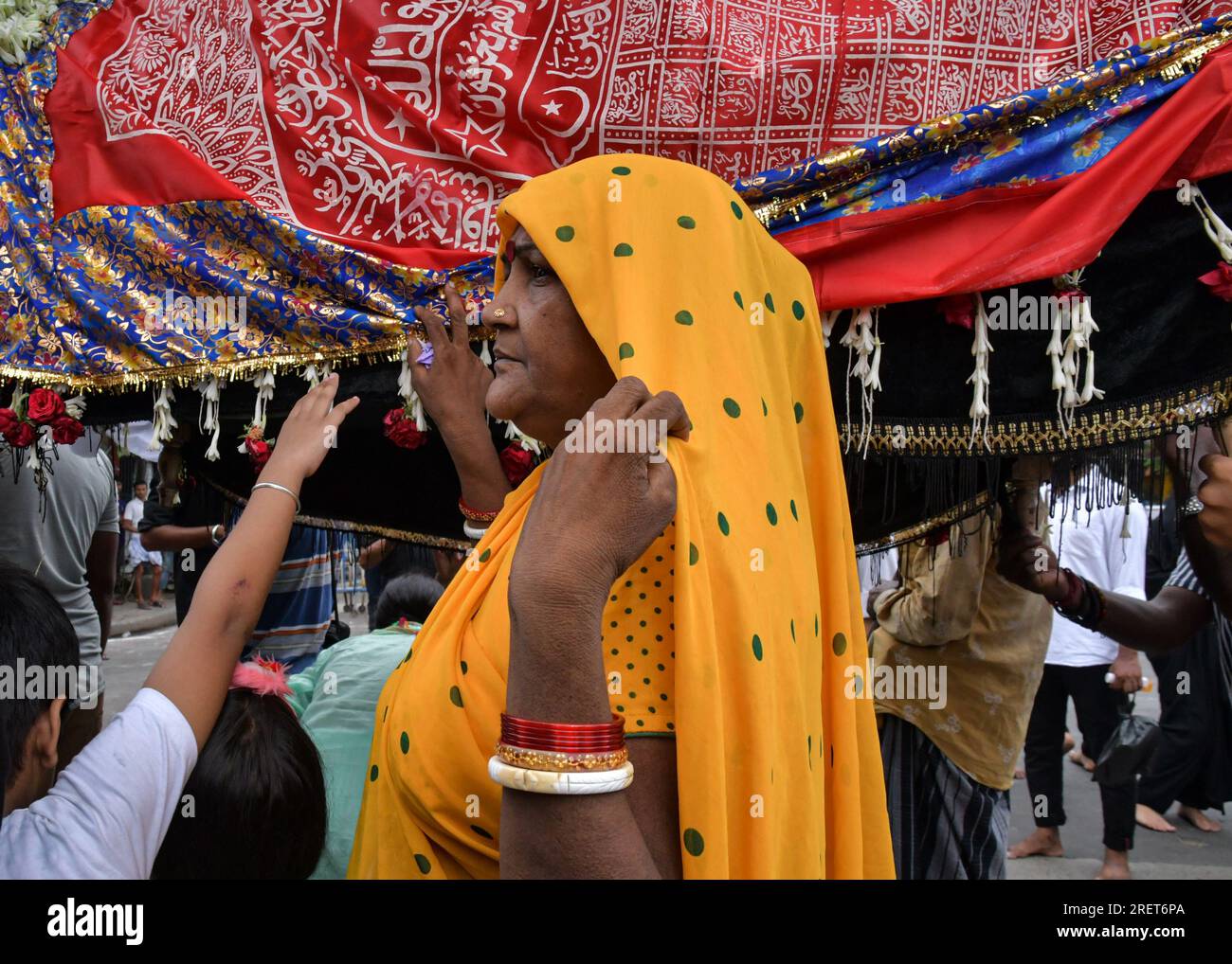 A Hindu woman takes blessings from a replica of the coffin of Prophet ...
