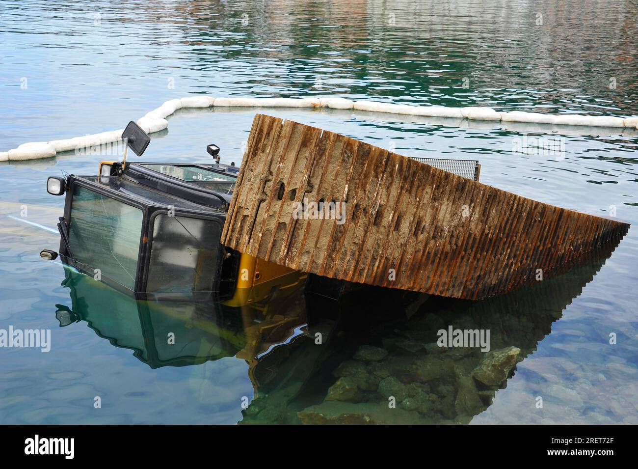 Excavator lies after accident in the water of the harbor Stock Photo ...