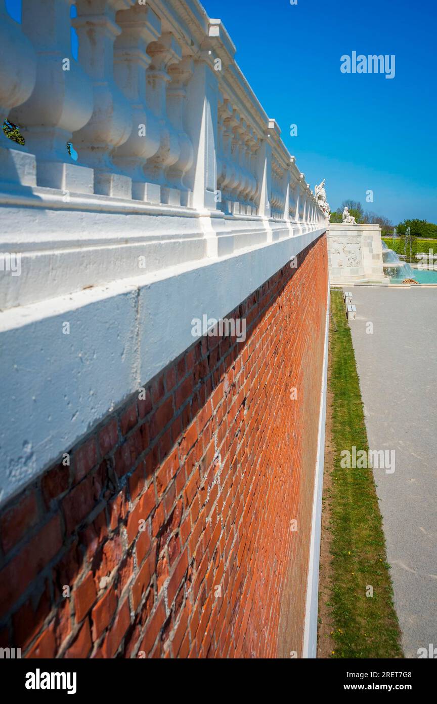 Wall of bricks leading to a well Stock Photo - Alamy