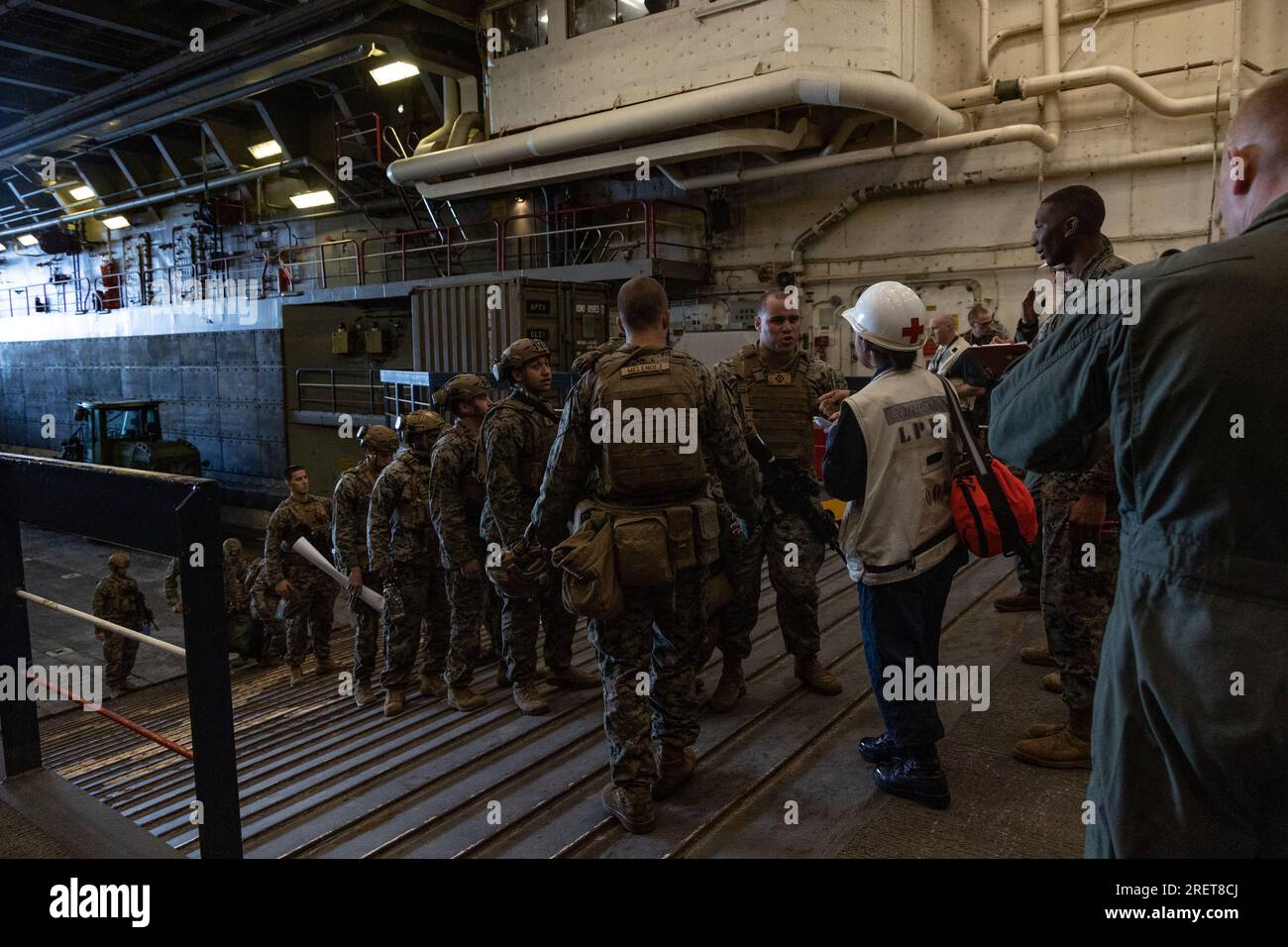 U.S. Marines aboard the USS Carter Hall cross deck to the San Antonio ...