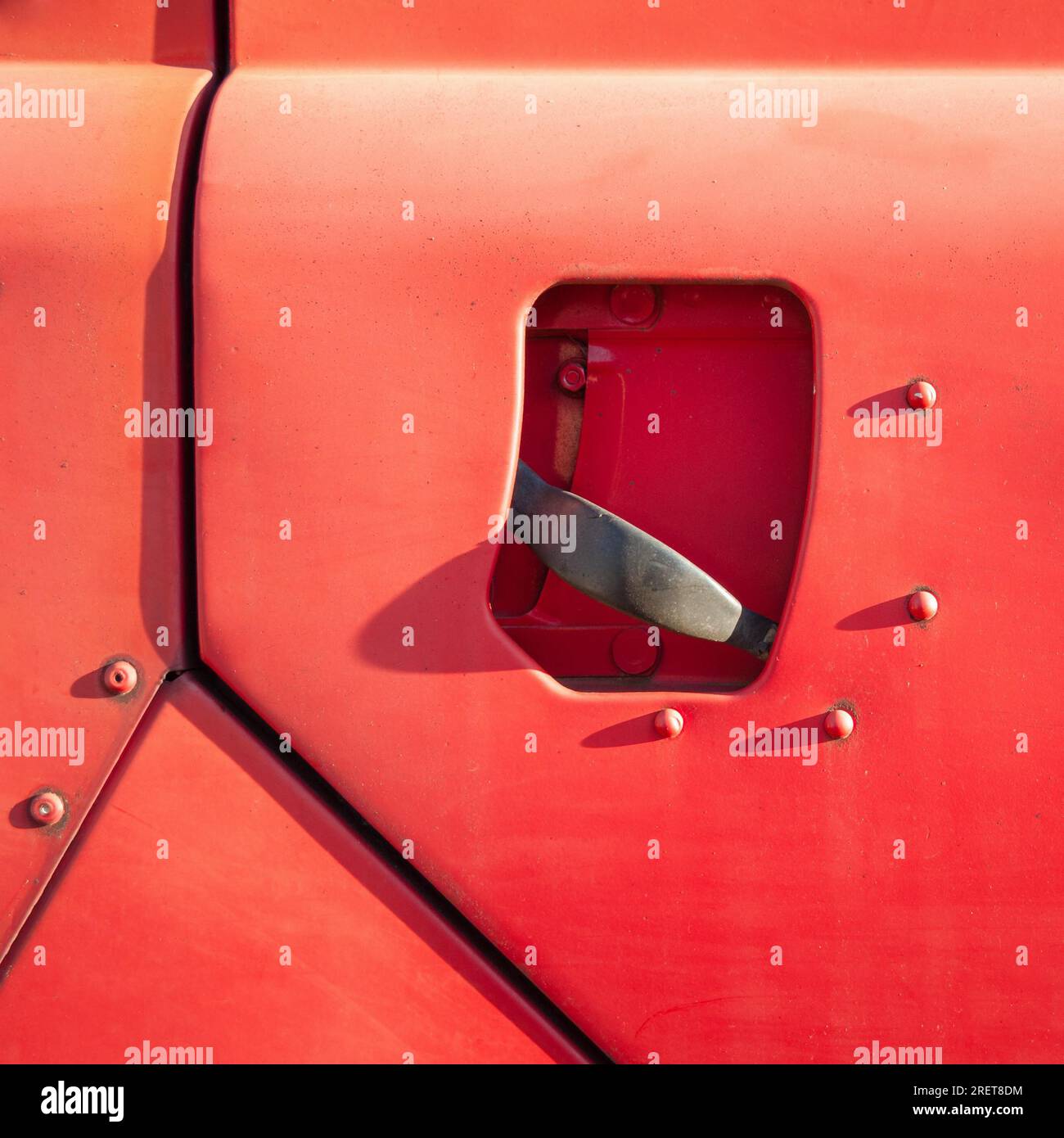 Car door handle of a red off-road oldtimer Stock Photo - Alamy