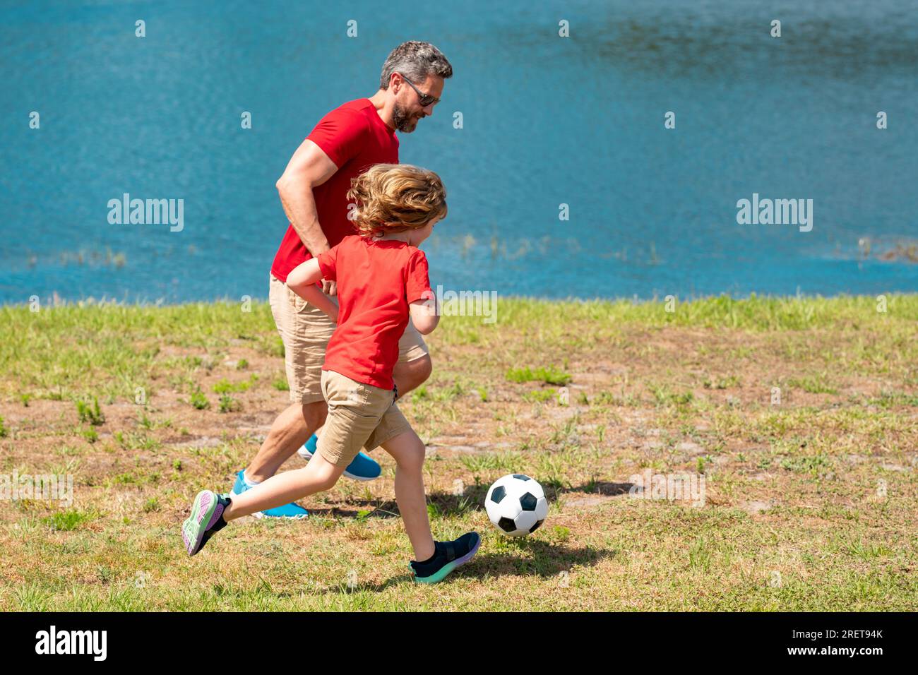 Father and son playing soccer football together. Father and son hours ...