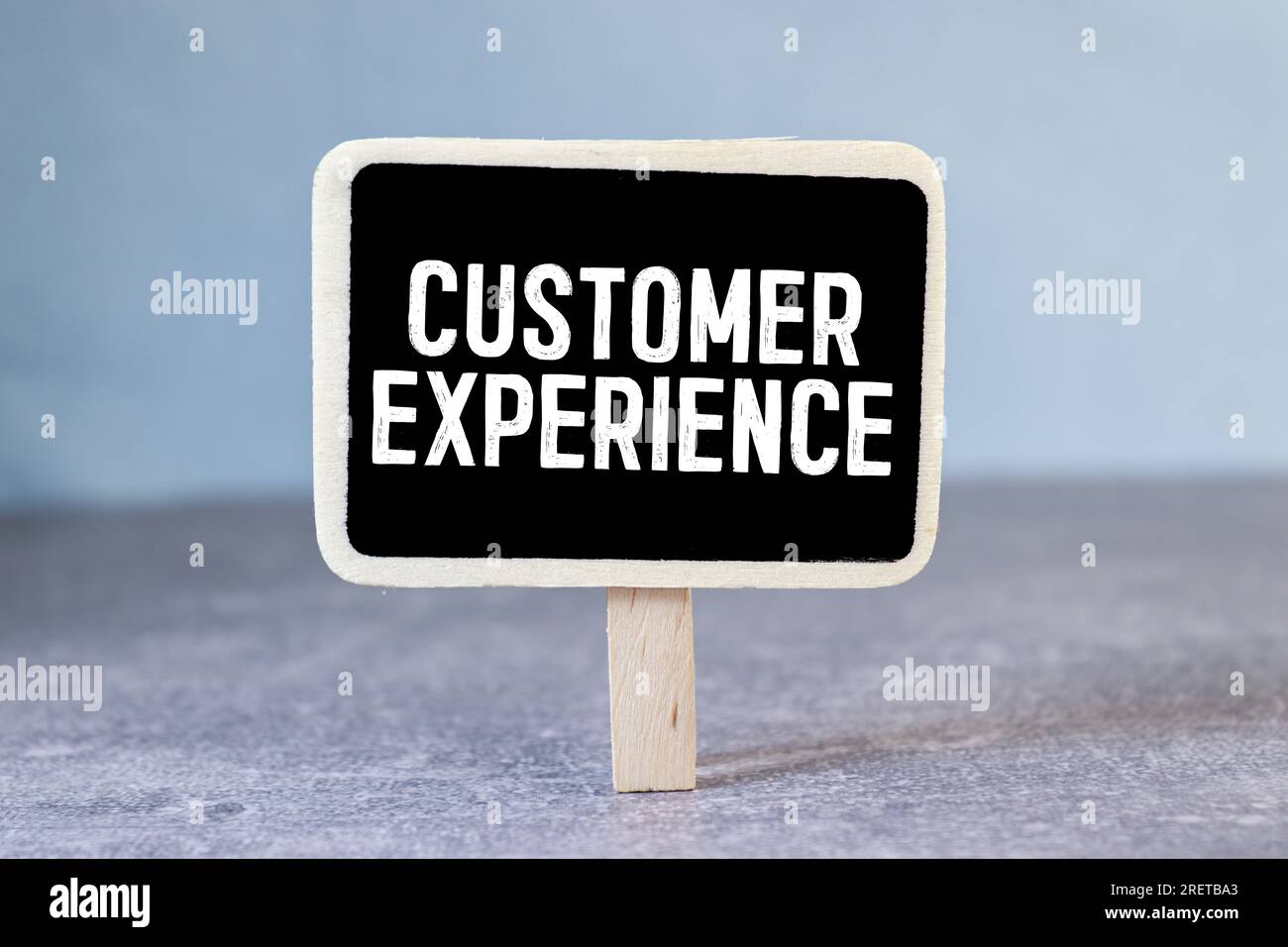 Customer Experience. text on white paper over torn paper background ...