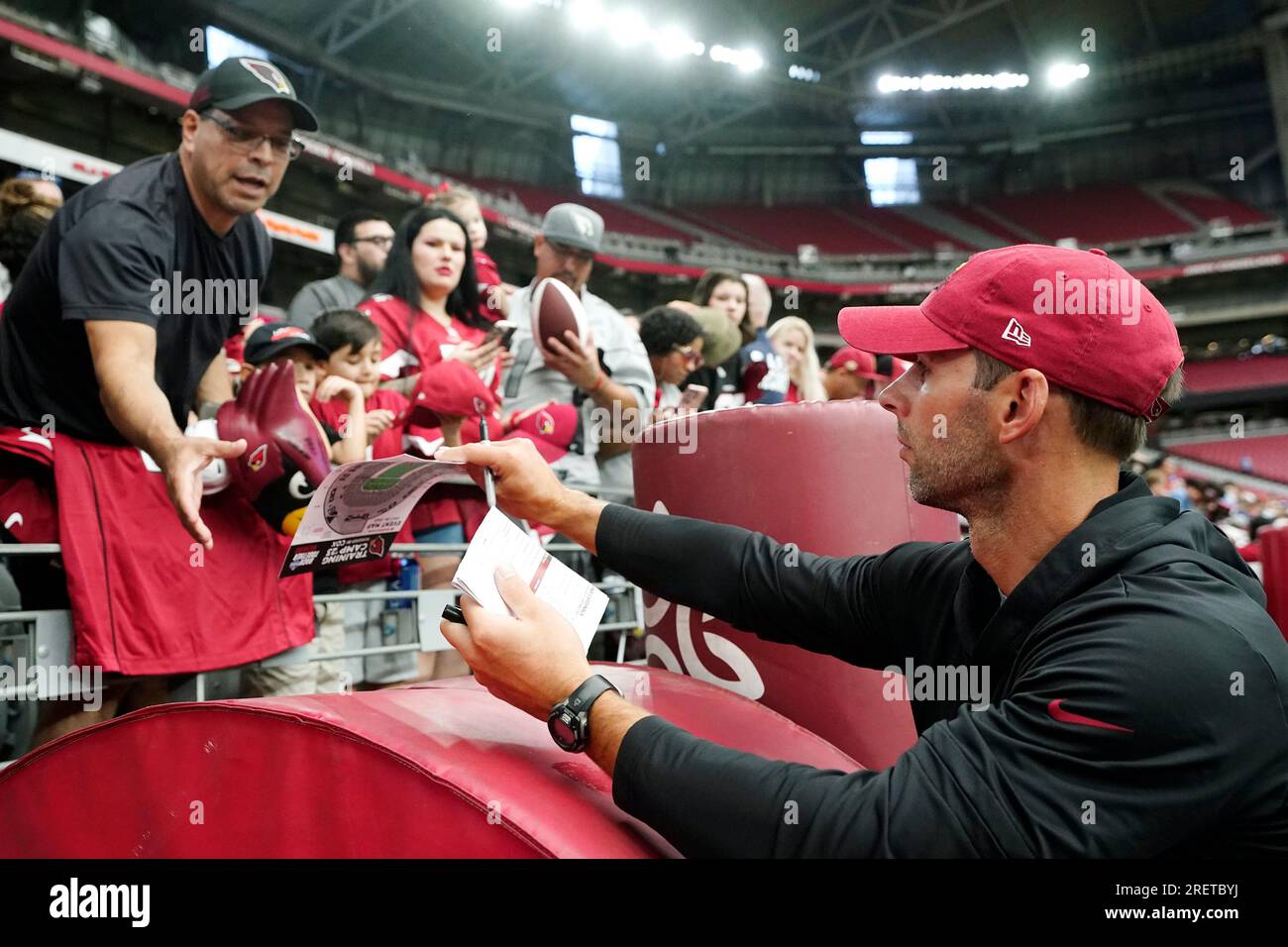 Arizona Cardinals coach Jonathan Gannon signs autographs after practice ...