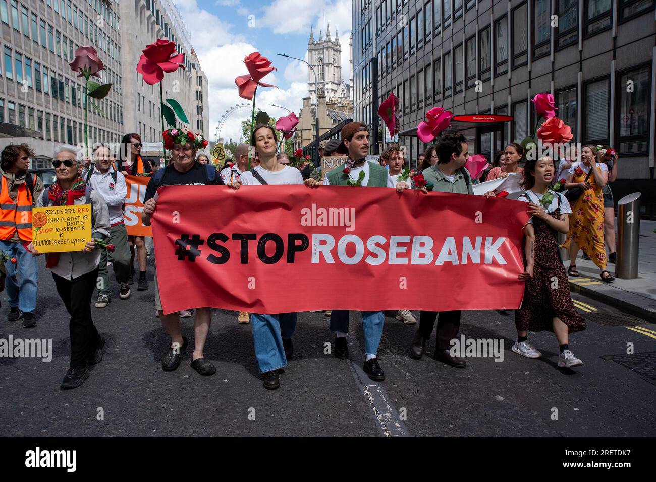 London, UK. 15th July, 2023. Protesters march with roses, placard and ...