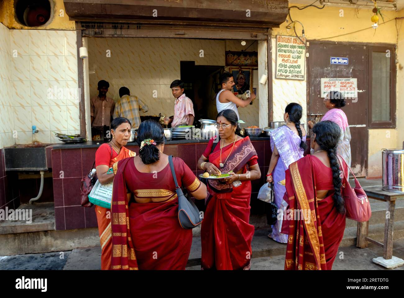 Women eating in front of a roadside eateries shop in Mylapore, Chennai ...