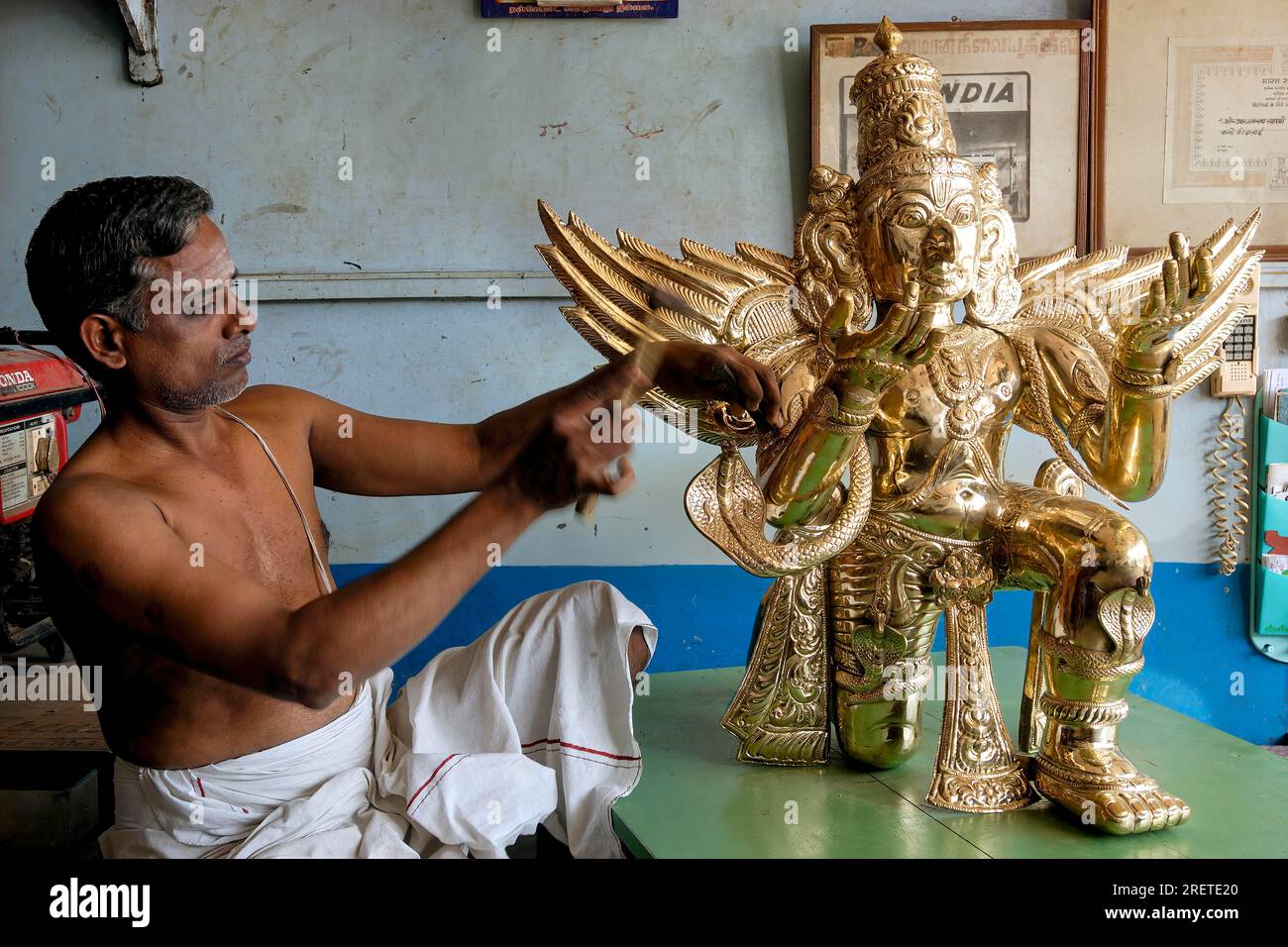 Sculptor making a bronze sculpture of Garuda the vahana of Lord Vishnu ...
