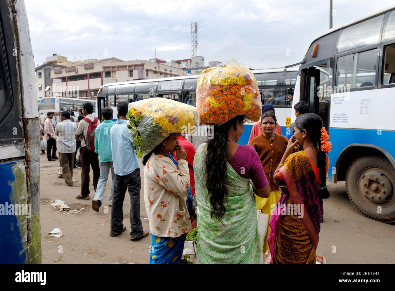 Flower sellers waiting for the Bus with flower bunch on head in ...