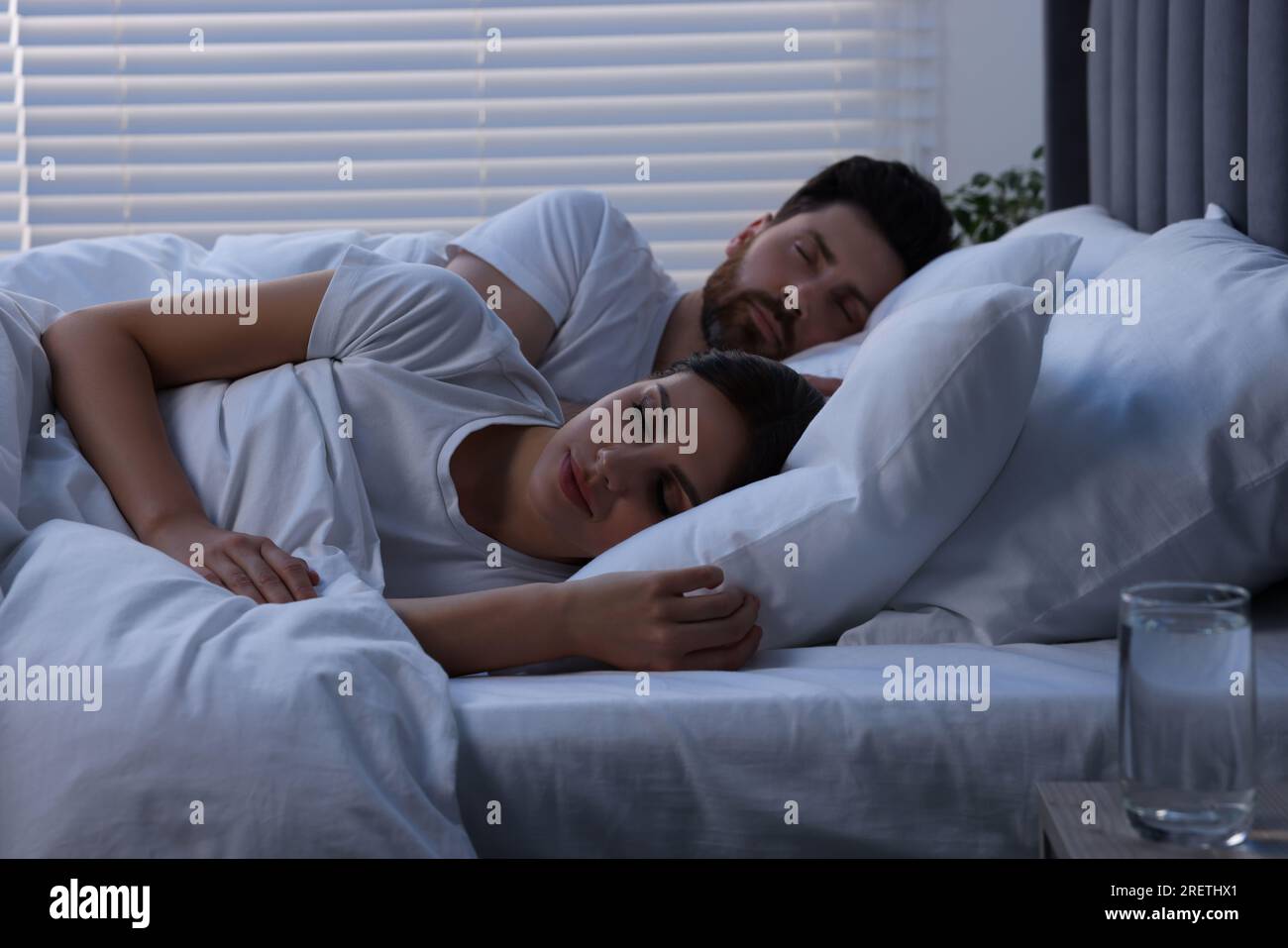 Lovely couple sleeping together in bed at night Stock Photo - Alamy