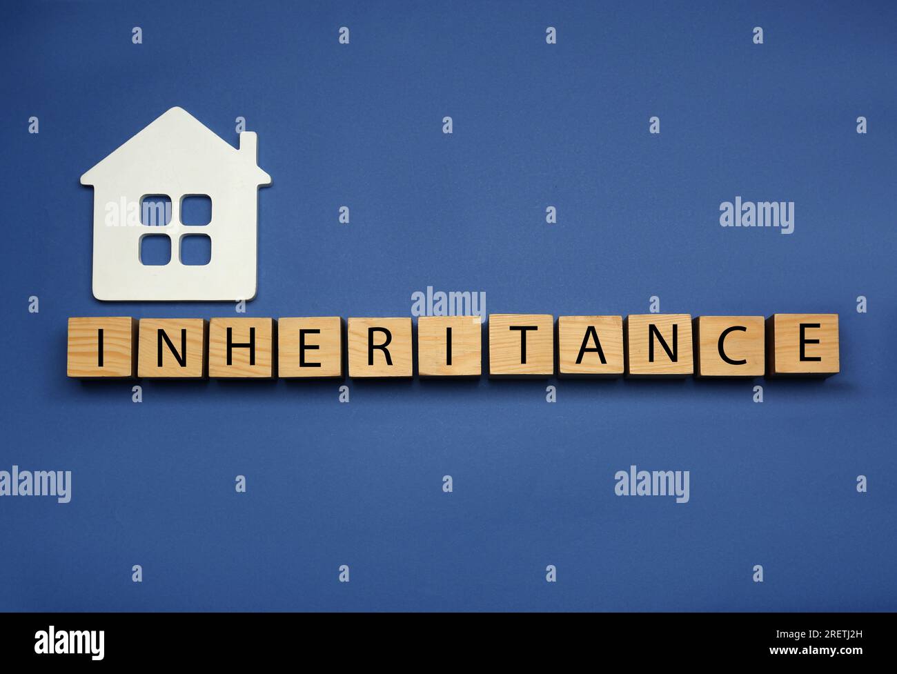 Word Inheritance made with wooden cubes and house model on blue ...