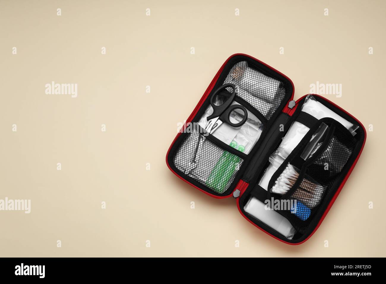 Open first aid kit on beige background, top view. Space for text Stock ...