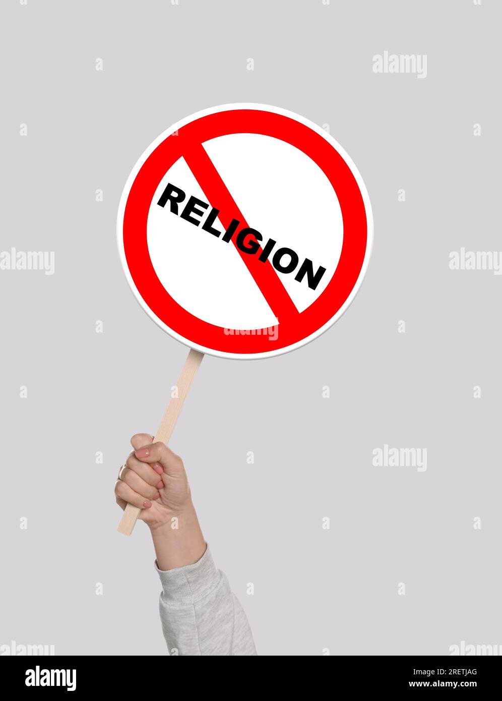 Atheism concept. Woman holding prohibition sign with crossed out word ...