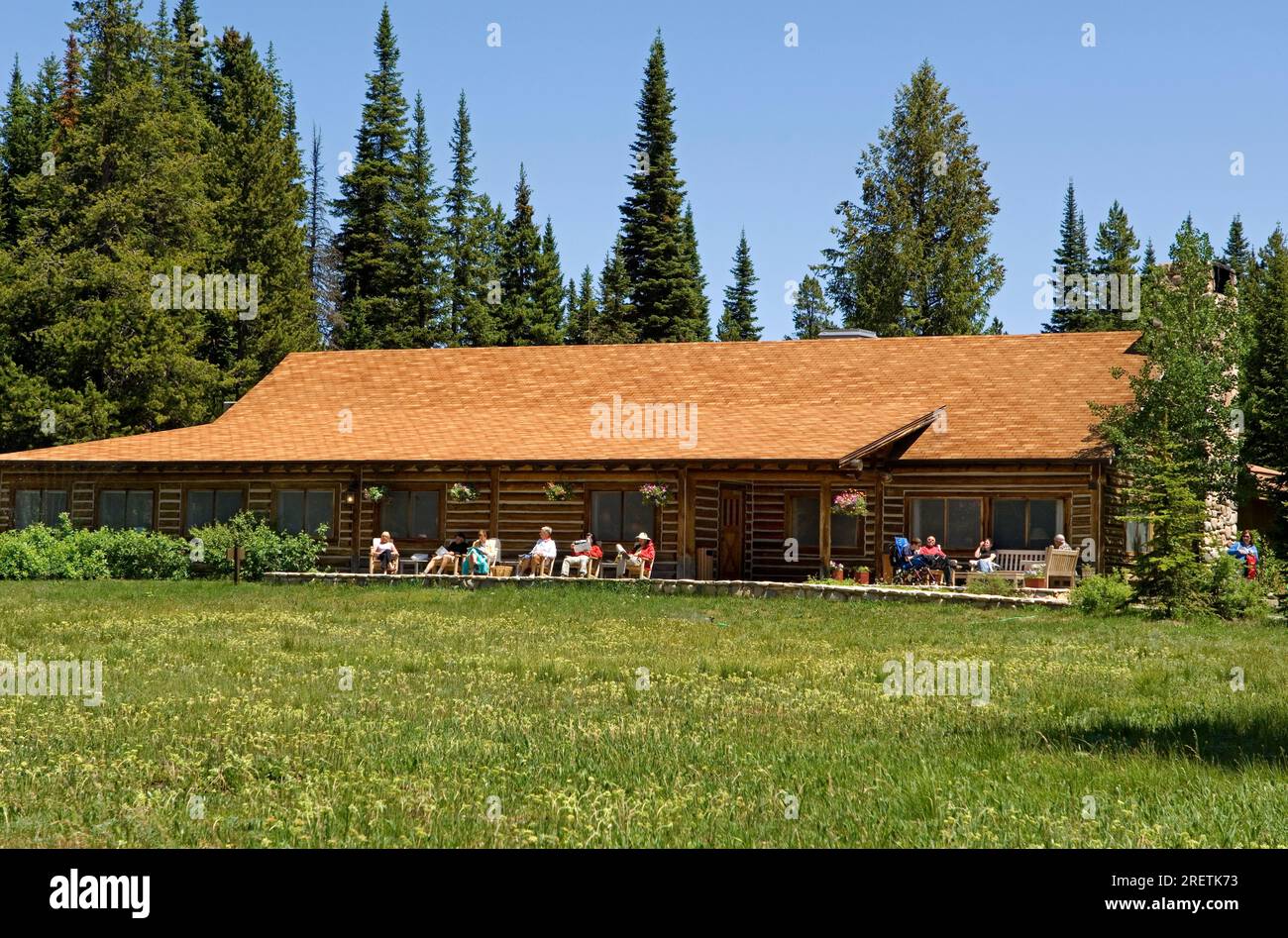 Visitors at log cabin lodge in Grand Tetons National Park, Wyoming, USA ...
