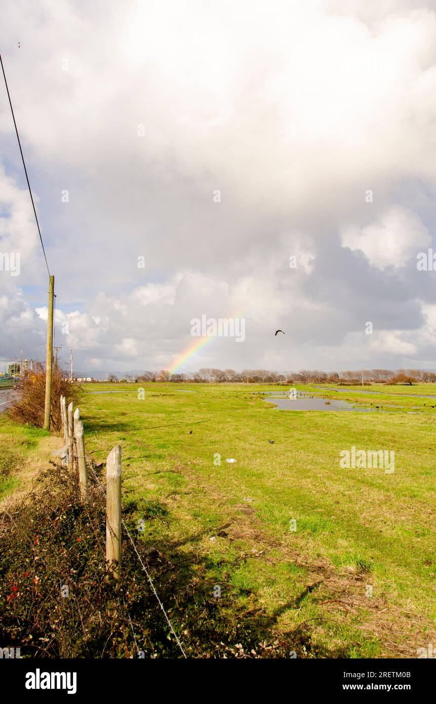 A partial rainbow in the horizon beyond the plains in the Lenga wetland ...