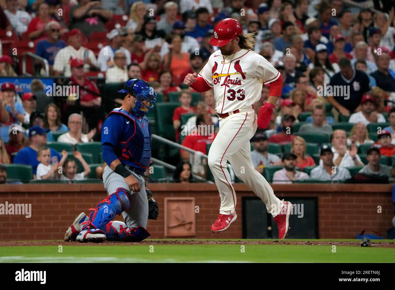 St. Louis Cardinals' Brendan Donovan (33) scores past Chicago Cubs ...