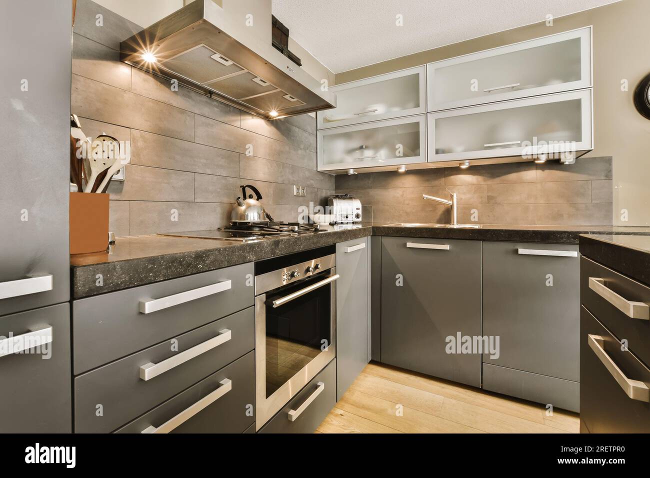 a modern kitchen with black counter tops and white trim on the cabinets ...