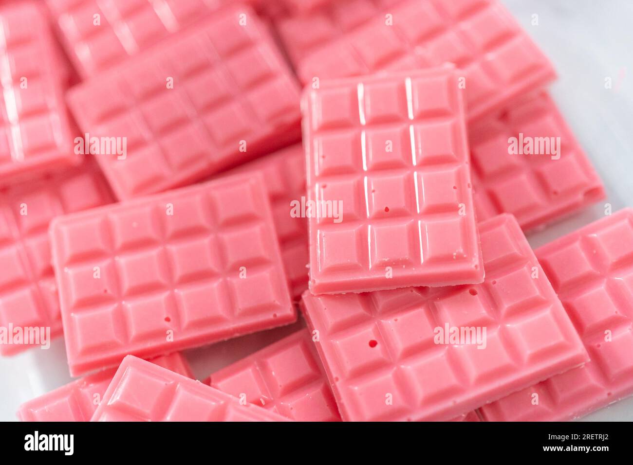 Mini pink chocolates Stock Photo - Alamy