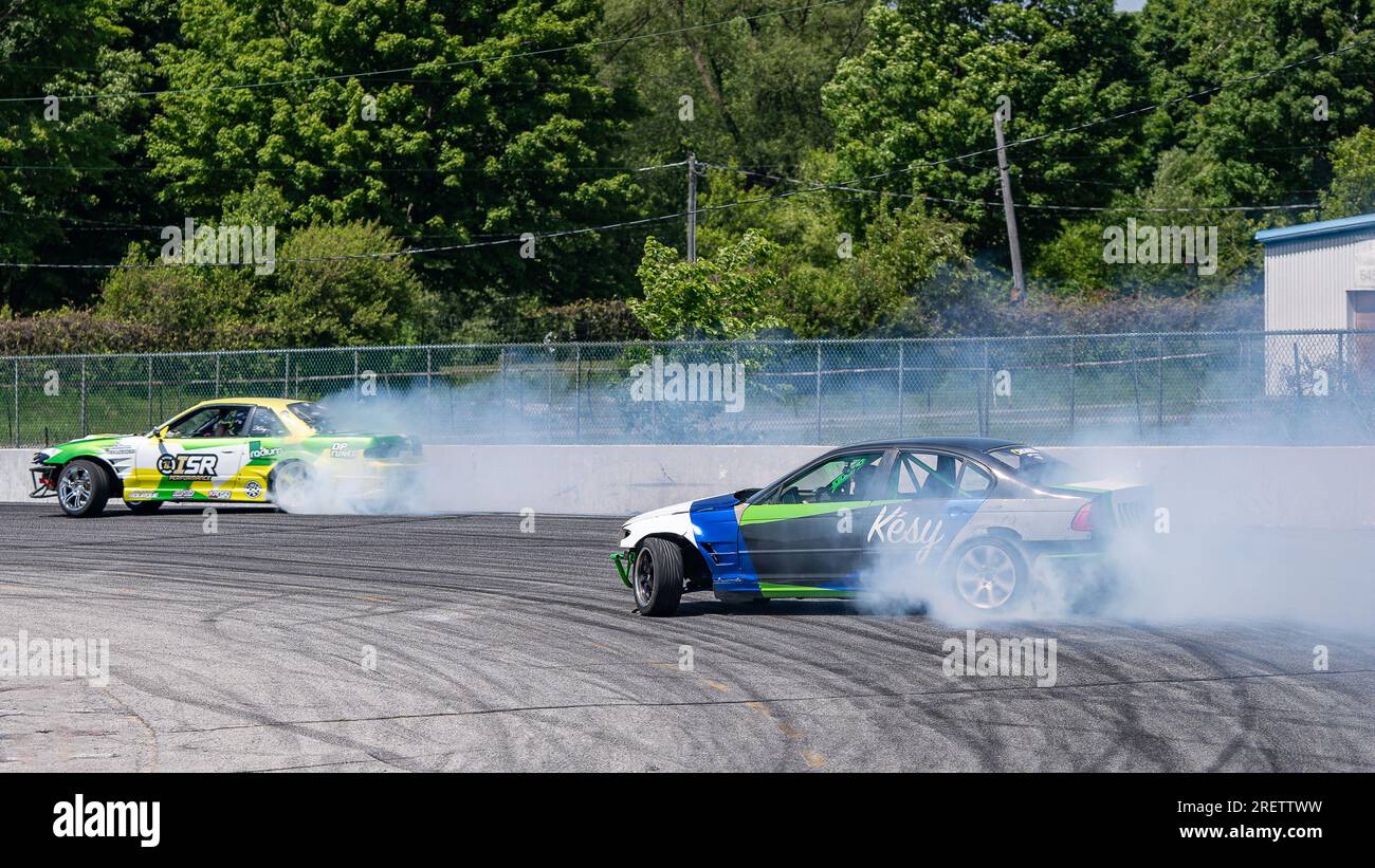 Car drifting auto racing event action with smoking tires - burning ...