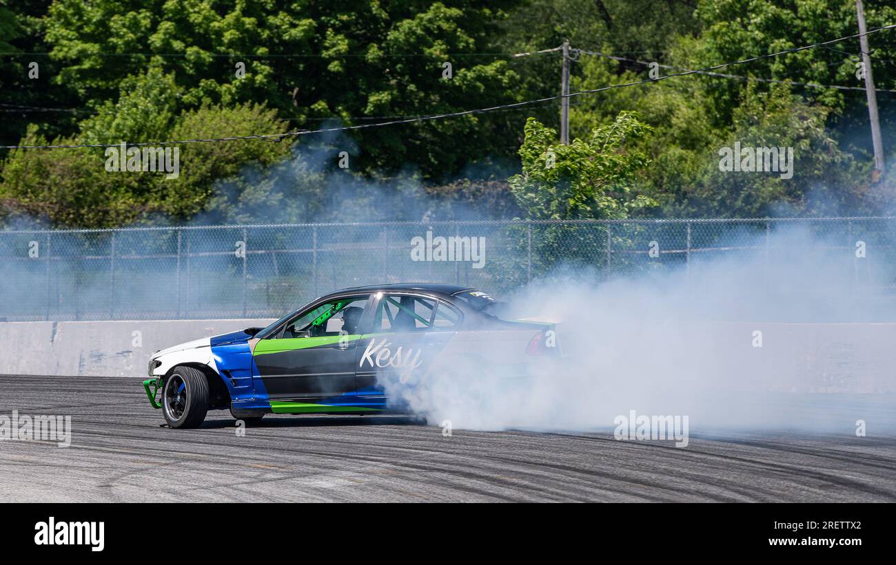 Car drifting auto racing event action with smoking tires - burning ...