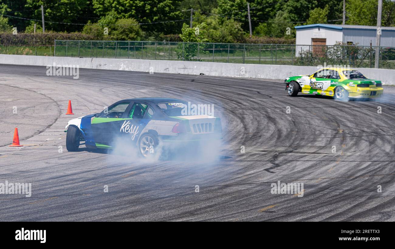 Car drifting auto racing event action with smoking tires - burning ...