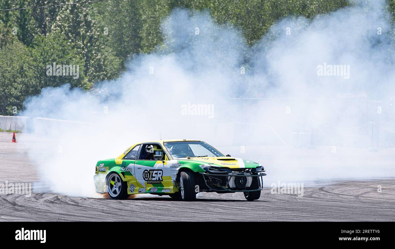 Car drifting auto racing event action with smoking tires - burning ...