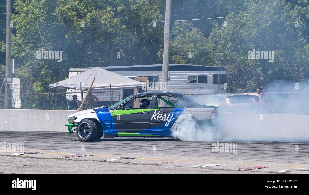 Car drifting auto racing event action with smoking tires - burning ...