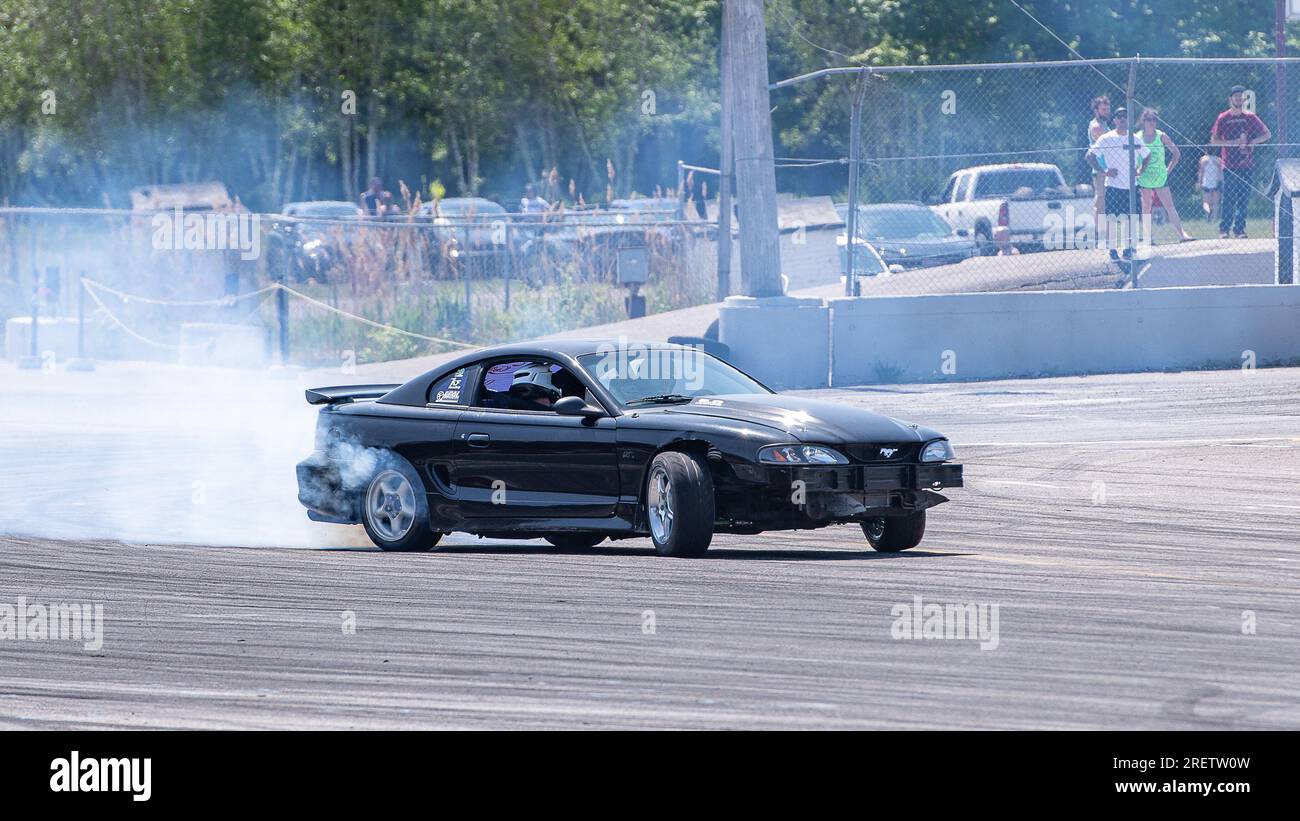 Car drifting auto racing event action with smoking tires - burning ...