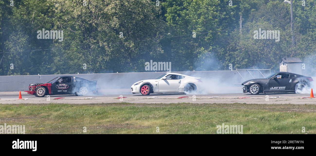 Car drifting auto racing event action with smoking tires - burning ...