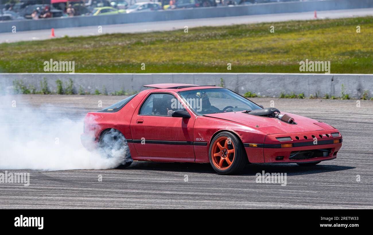 Car drifting auto racing event action with smoking tires - burning ...
