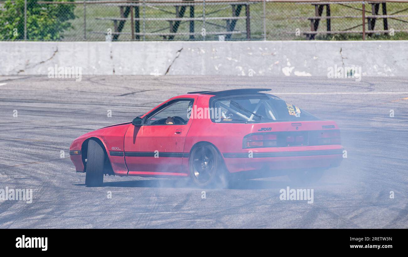 Car drifting auto racing event action with smoking tires - burning ...