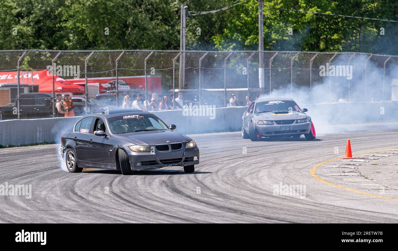 Car drifting auto racing event action with smoking tires - burning ...
