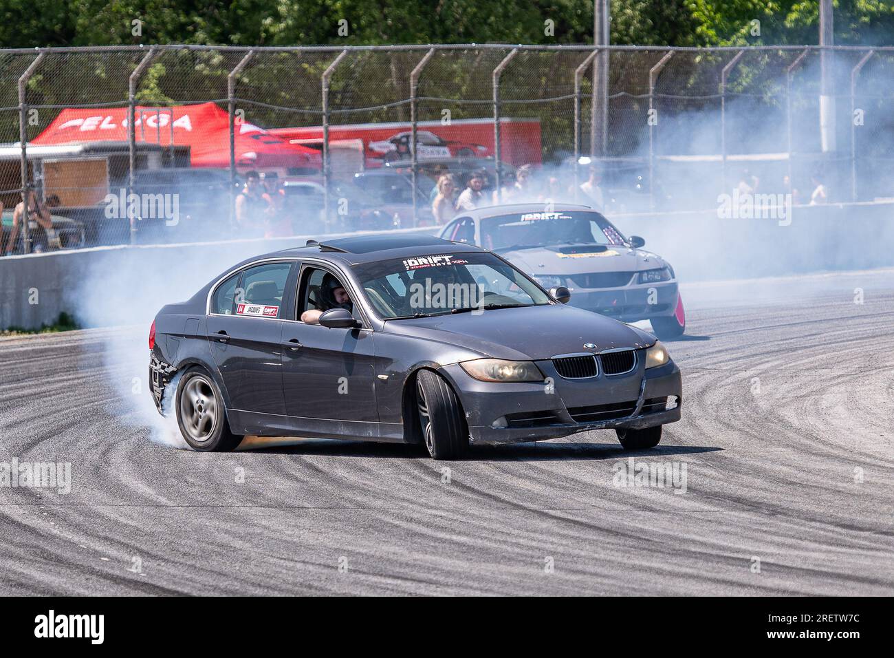 Car drifting auto racing event action with smoking tires - burning ...
