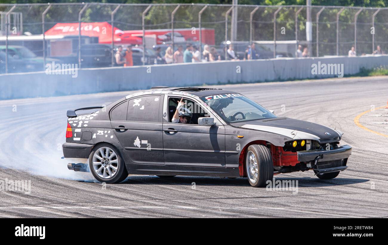 Car drifting auto racing event action with smoking tires - burning ...