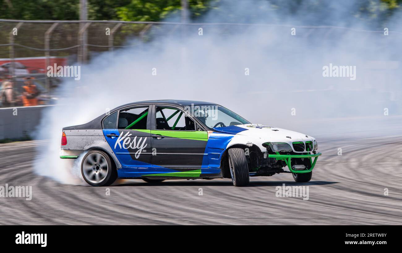 Car drifting auto racing event action with smoking tires - burning ...