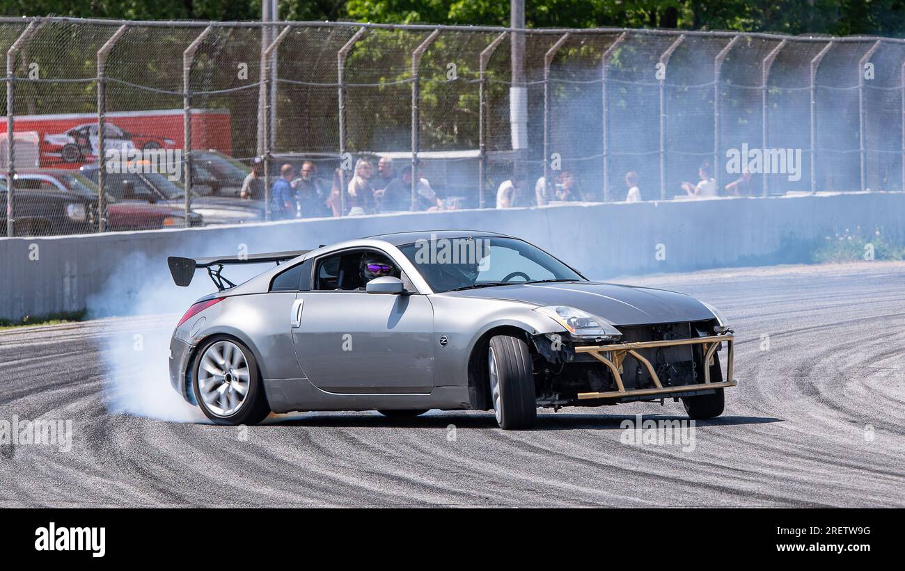 Car drifting auto racing event action with smoking tires - burning ...